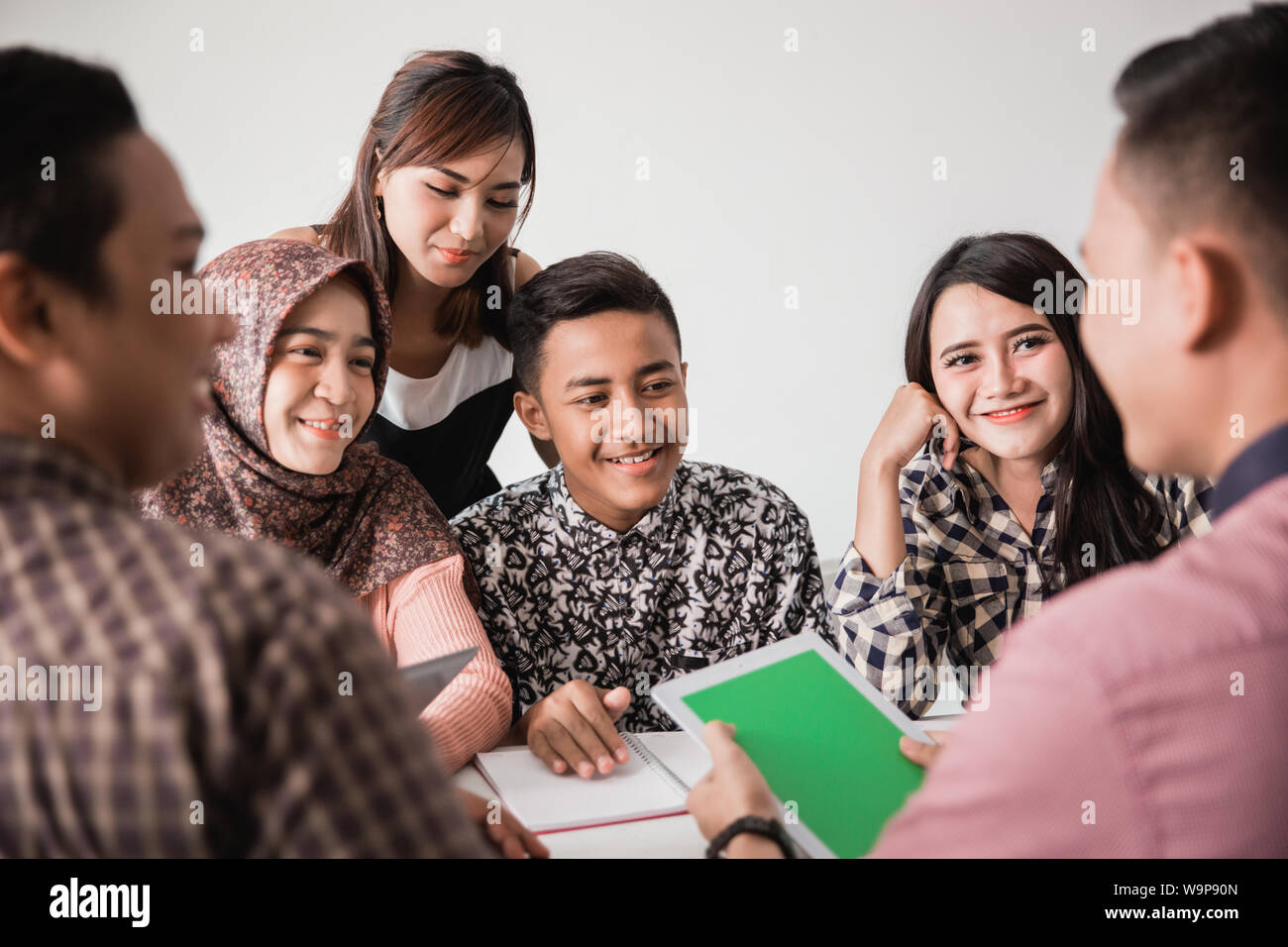 Happy friends studying together Stock Photo - Alamy