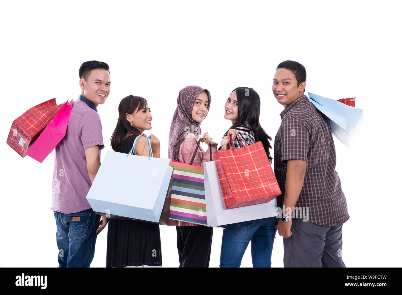 Group of friends carrying shopping bag Stock Photo - Alamy