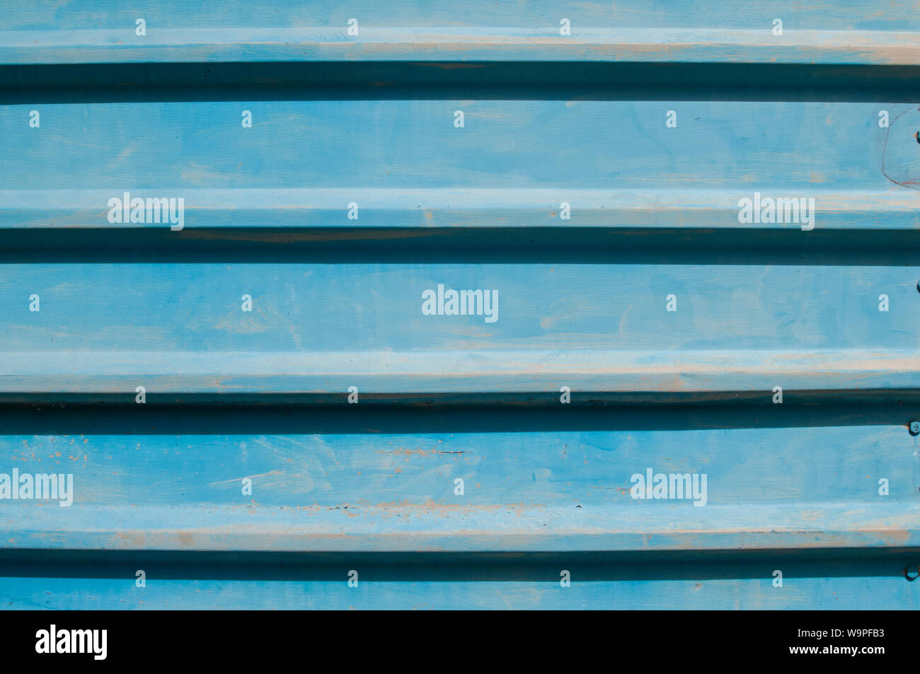 Weathered blue painted tin corrugated steel sheet closeup as metal ...