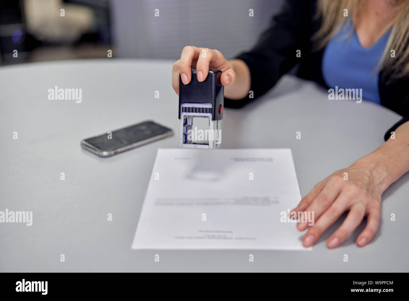 office worker puts a stamp on the document Stock Photo - Alamy