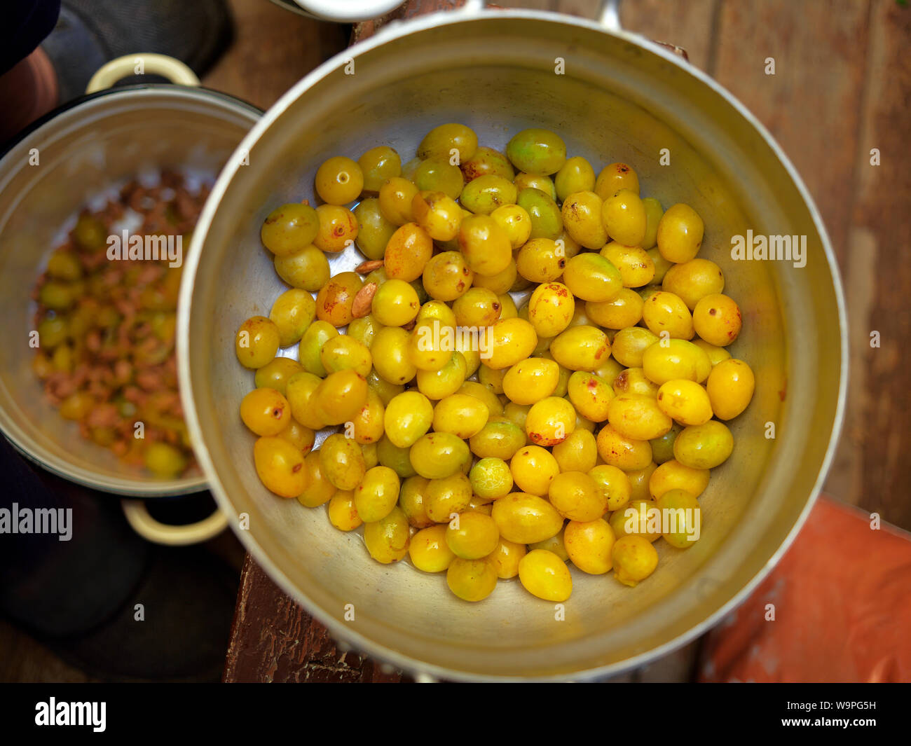 Overhead close-up of yellow plums in two casseroles Stock Photo - Alamy
