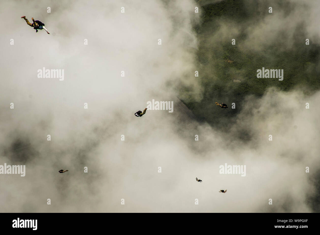 U.S. Armed Service members pinpoint their landing spot during parachute ...