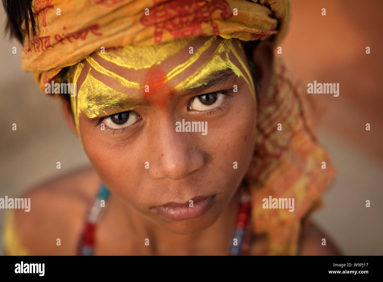Young Sadhu boy on the ghats of Ganges in Varanasi, India. Varanasi is ...