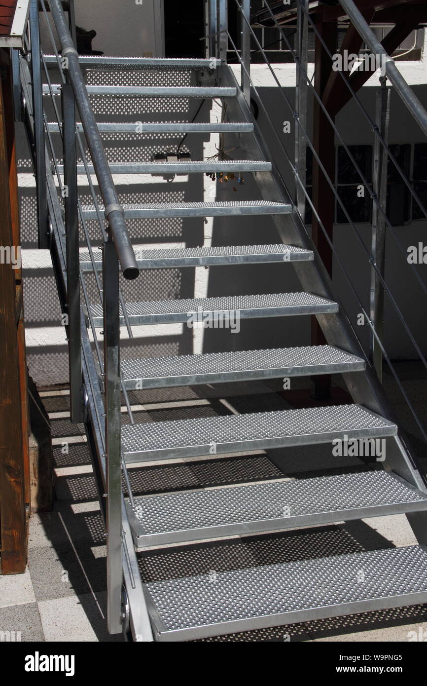 a galvanized steel staircase with railing Stock Photo - Alamy