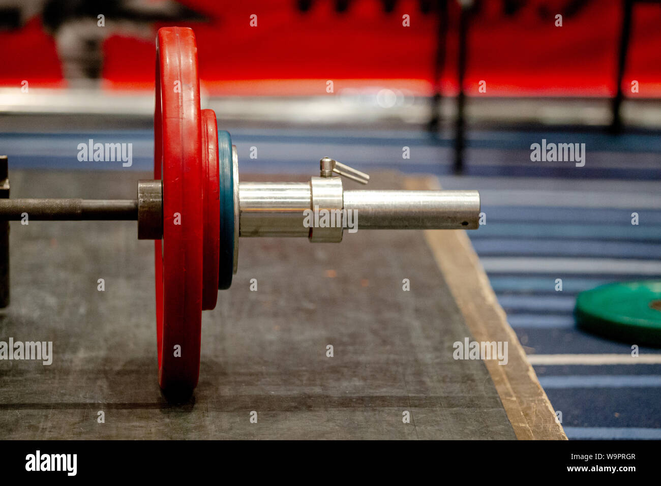 bar with plates on ground for deadlift competition Stock Photo - Alamy