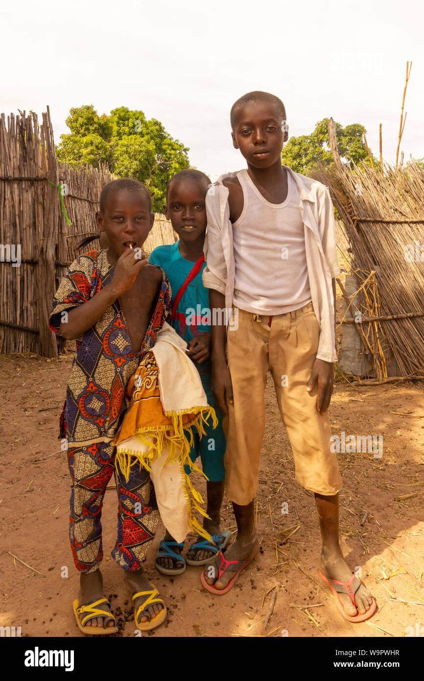 GEORGETOWN, GAMBIA- JAN 7, 2014: Poor farm boys. Smiling and wearing ...