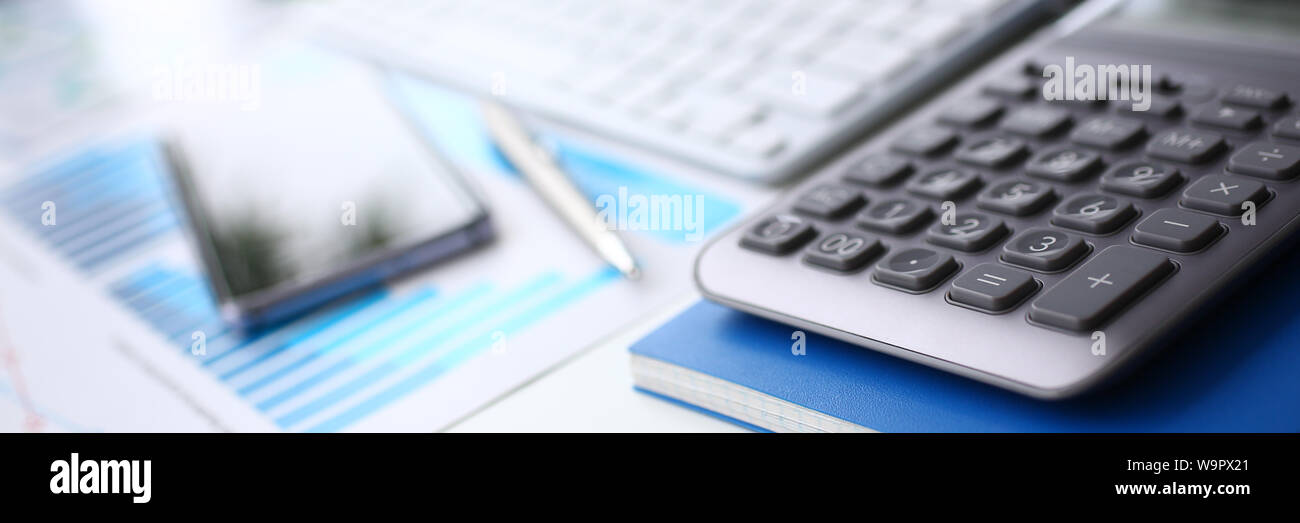 Silver calculator and financial statistics on clipboard Stock Photo - Alamy