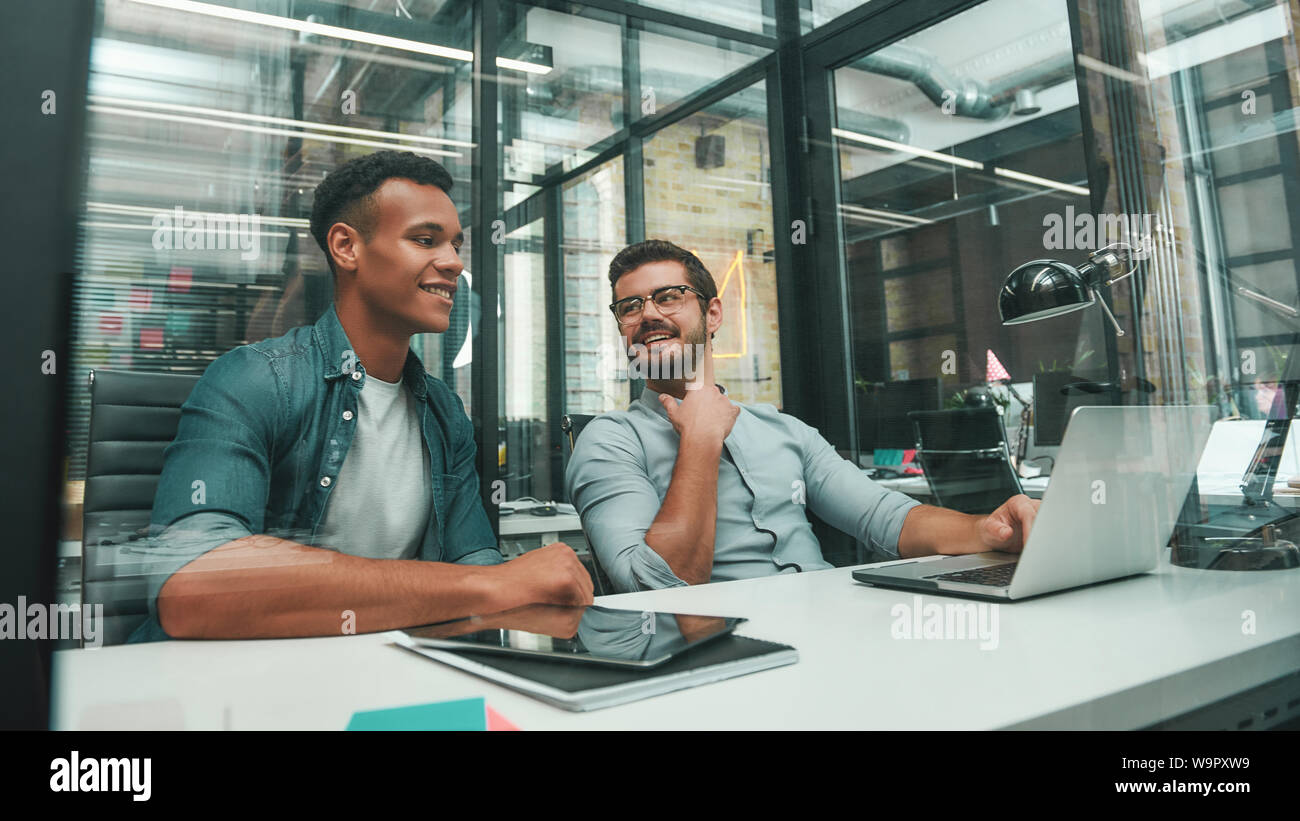 Good communication. Two young and handsome men talking with each other ...