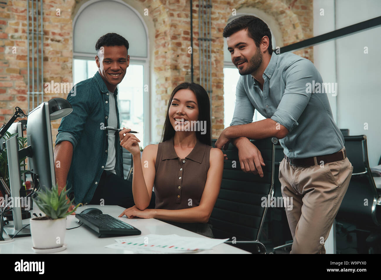 Business people pointing at monitor hi-res stock photography and images - Alamy