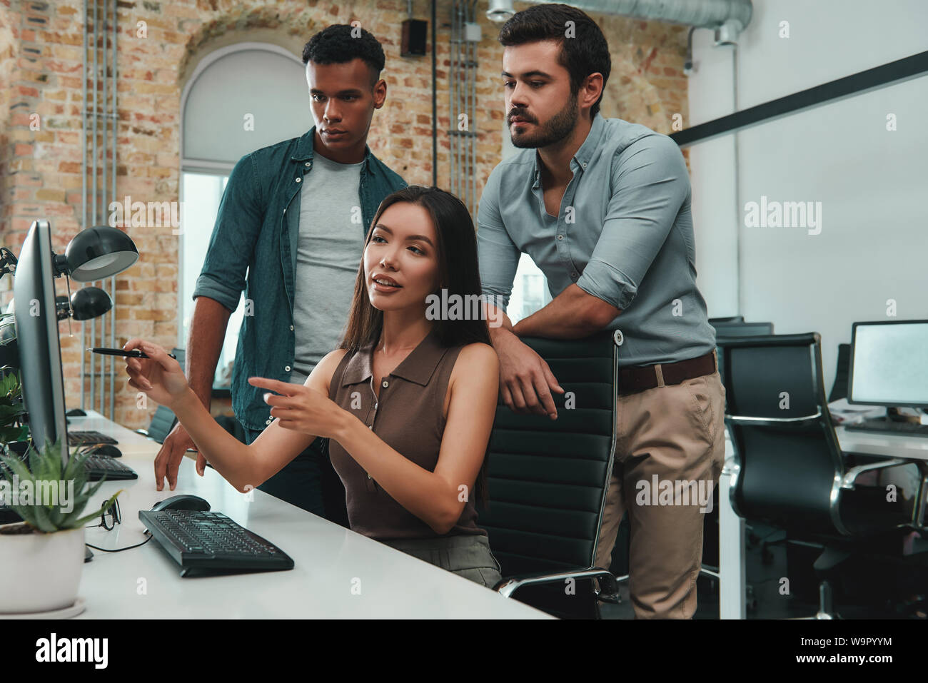Business people pointing at monitor hi-res stock photography and images ...