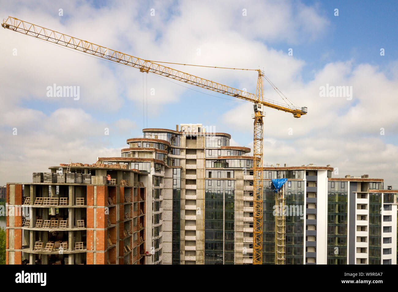 Apartment or office tall building under construction. Brick walls ...