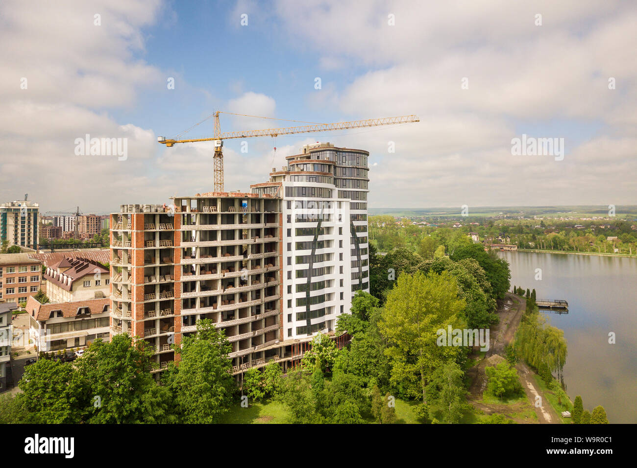 Apartment or office tall building unfinished under construction among ...