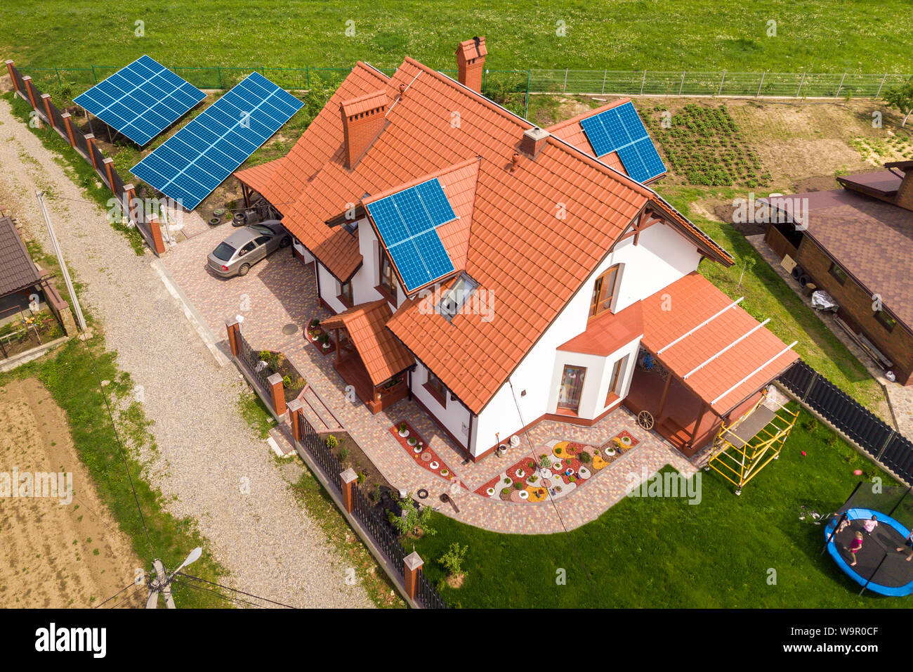 Aerial top view of new modern residential house cottage with blue shiny ...