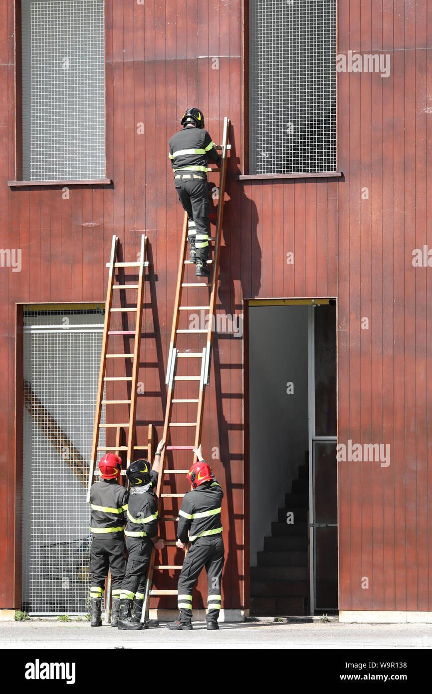 many fireman at fire station during a practice training Stock Photo - Alamy