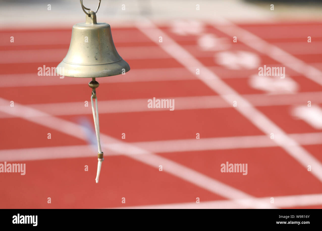 bell in an athletics track to signal the last lap to the athletes Stock ...