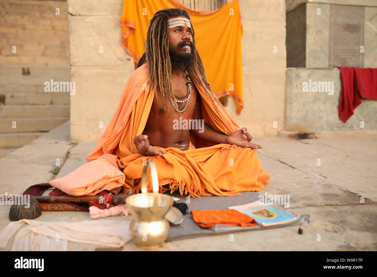 Sadhu (holy man) on the ghats of Ganges in Varanasi, India. Varanasi is ...