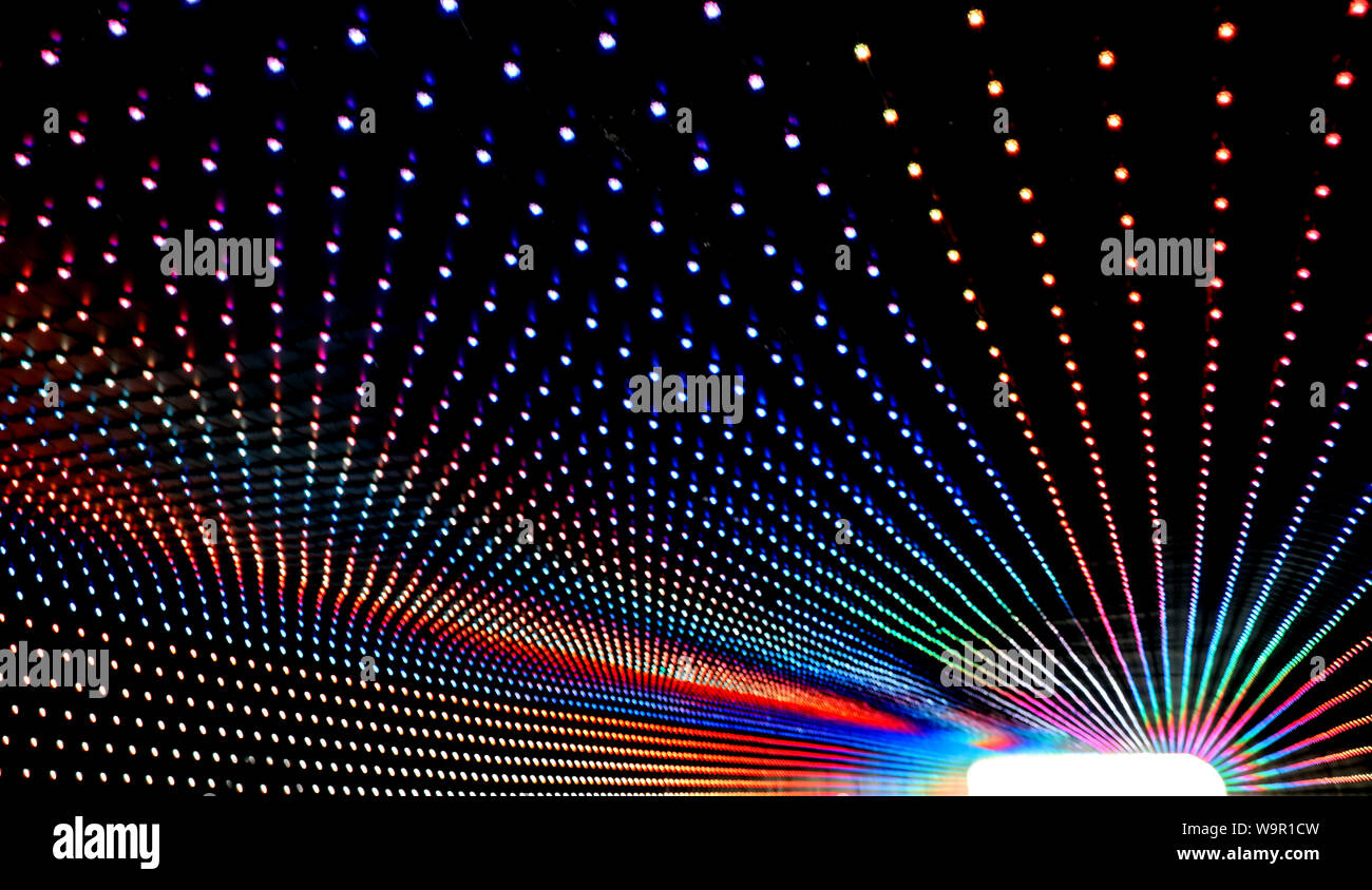 tunnel with white light exit and the colored led lights on the black ...