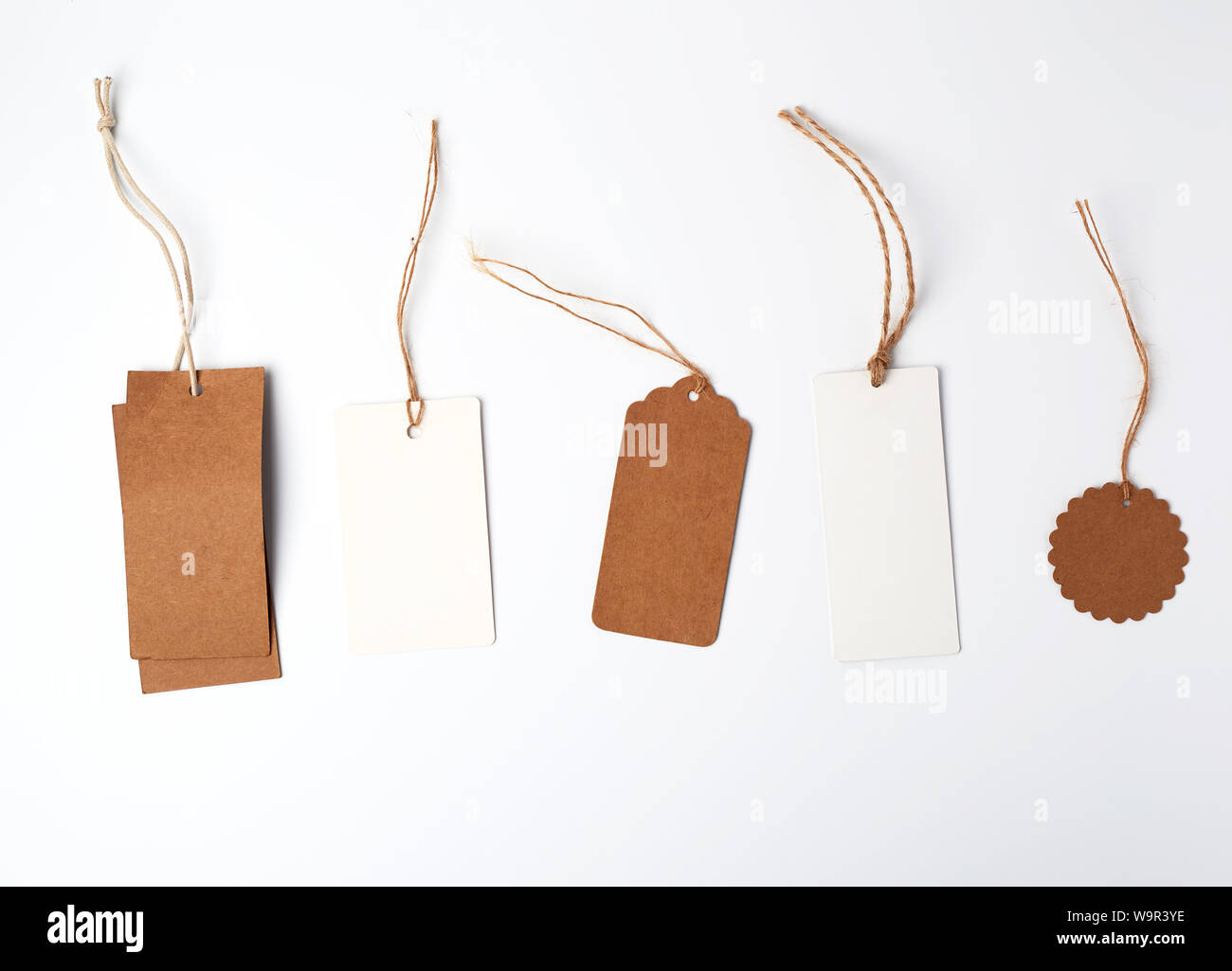 round and rectangular price tags from brown and white paper hang on a ...