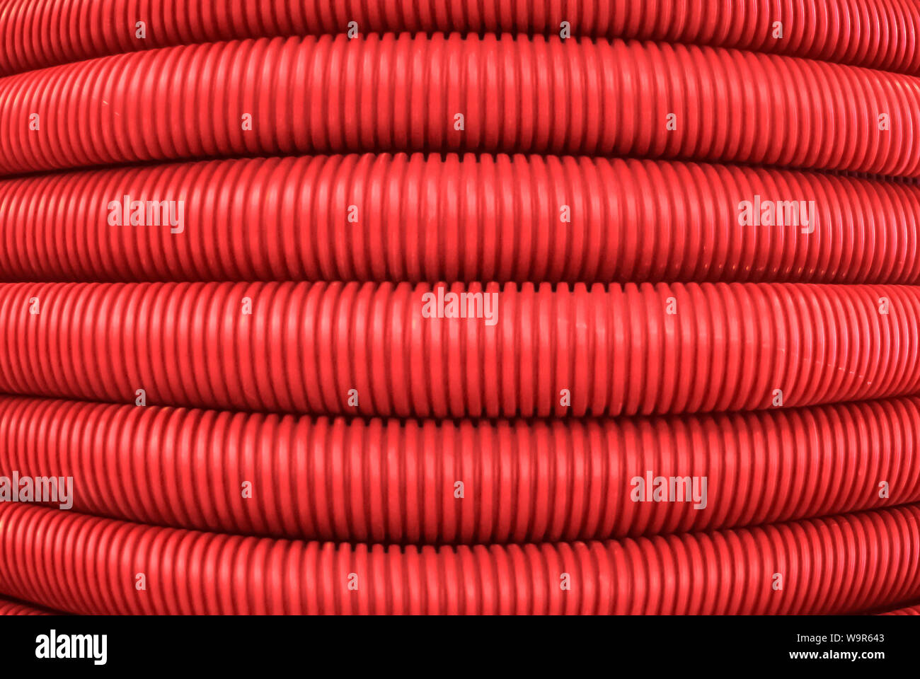 background - red corrugated flexible polymer tubes close up Stock Photo ...