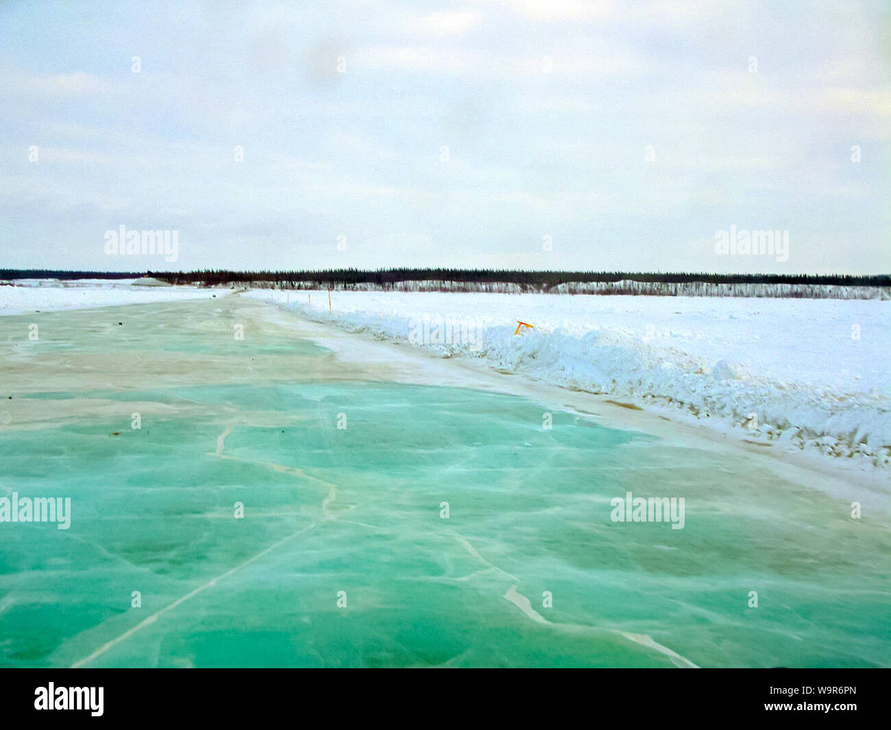 The frozen river thaws. Algae under the ice painted it in green Stock ...