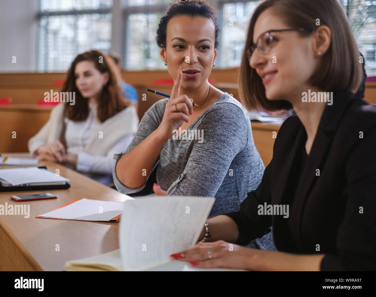 Multinational group of students in an auditorium Stock Photo - Alamy