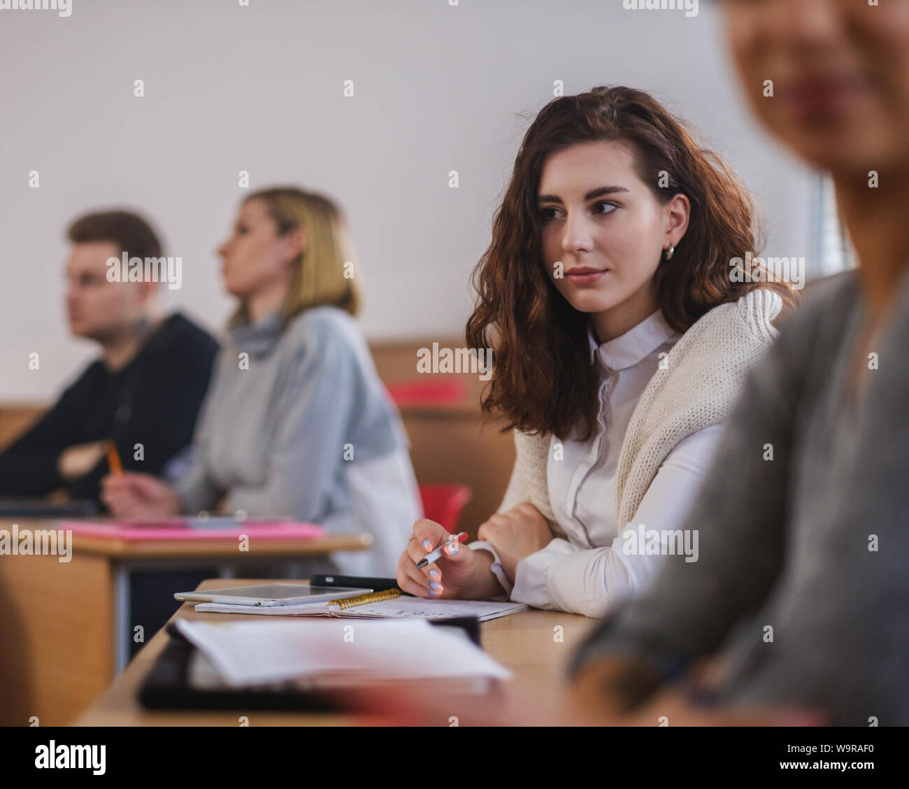 Beautiful girl taking notes in multinational group of students in an ...