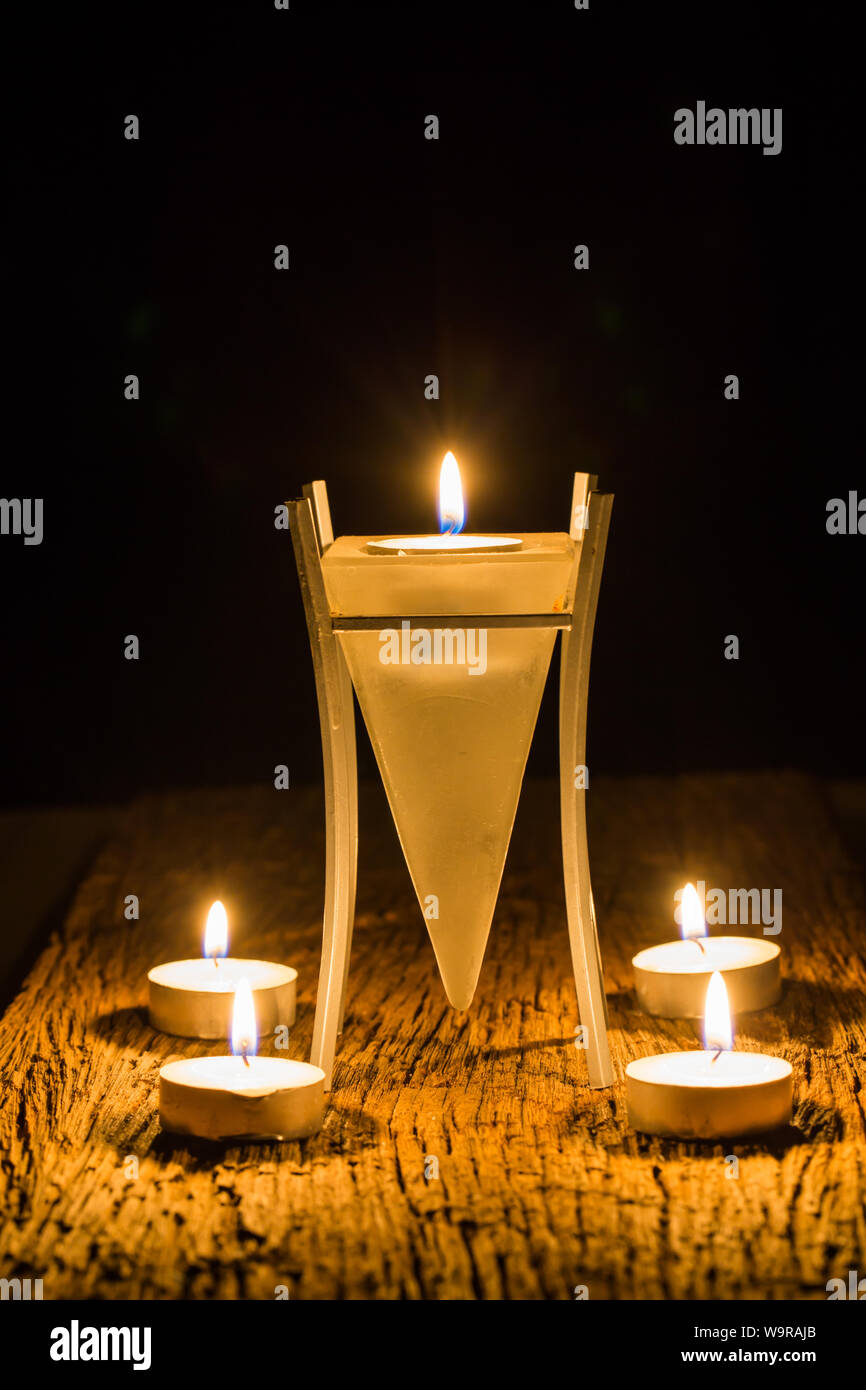 candle light in dark on wood texture Stock Photo - Alamy