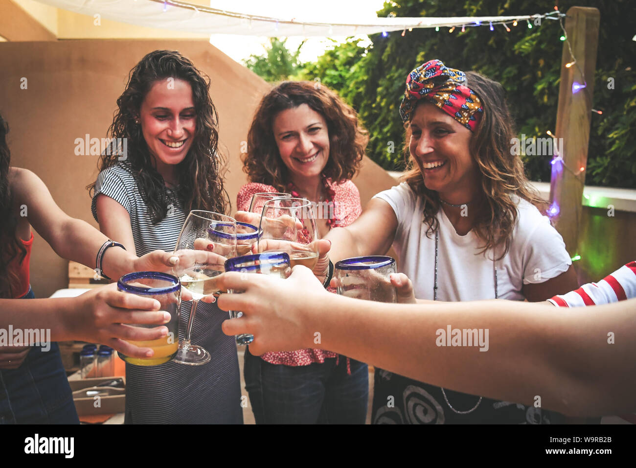 Friends cheering with glasses hi-res stock photography and images - Alamy