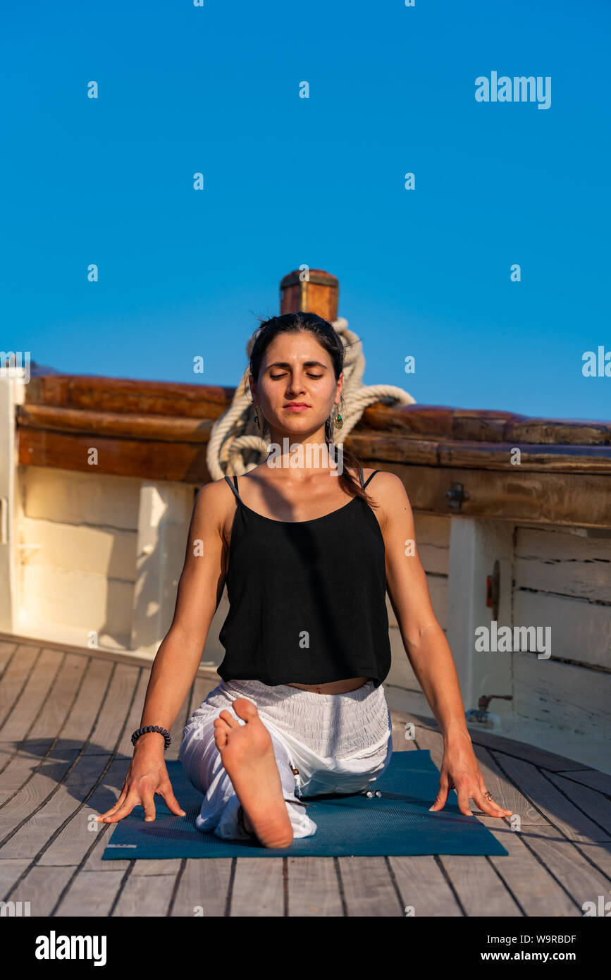 Woman practicing Yoga on a sailing yacht at sea Stock Photo - Alamy