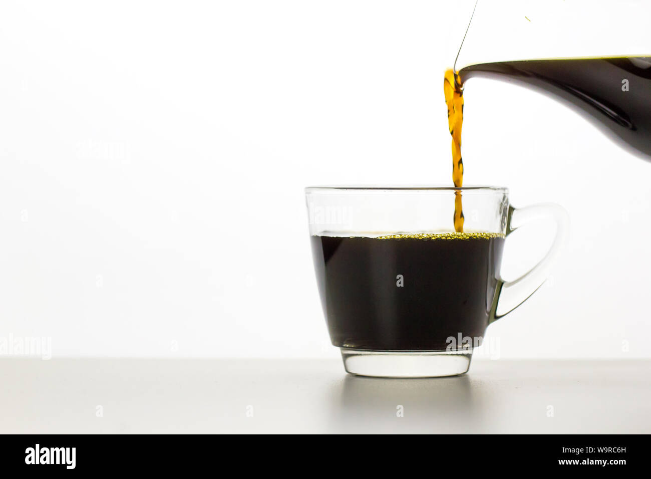 Pouring Coffee into a cup on white background Stock Photo - Alamy