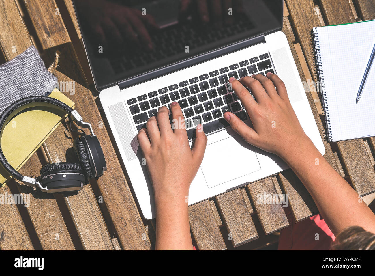 University student playing with laptop. Close up view of a young boy ...