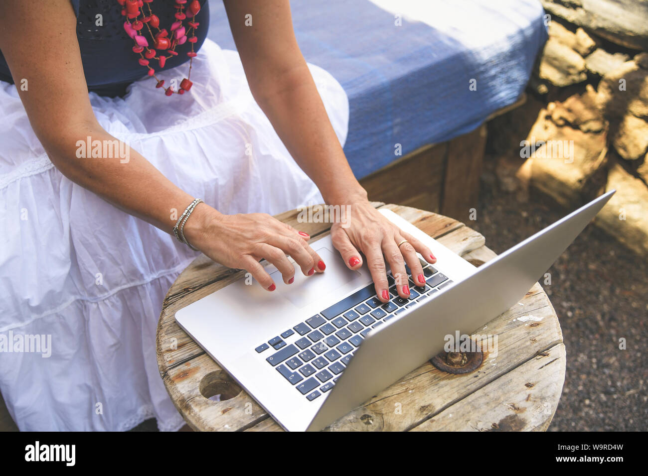 Close up view of woman hands typing on a laptop keyboard. Trendy girl ...