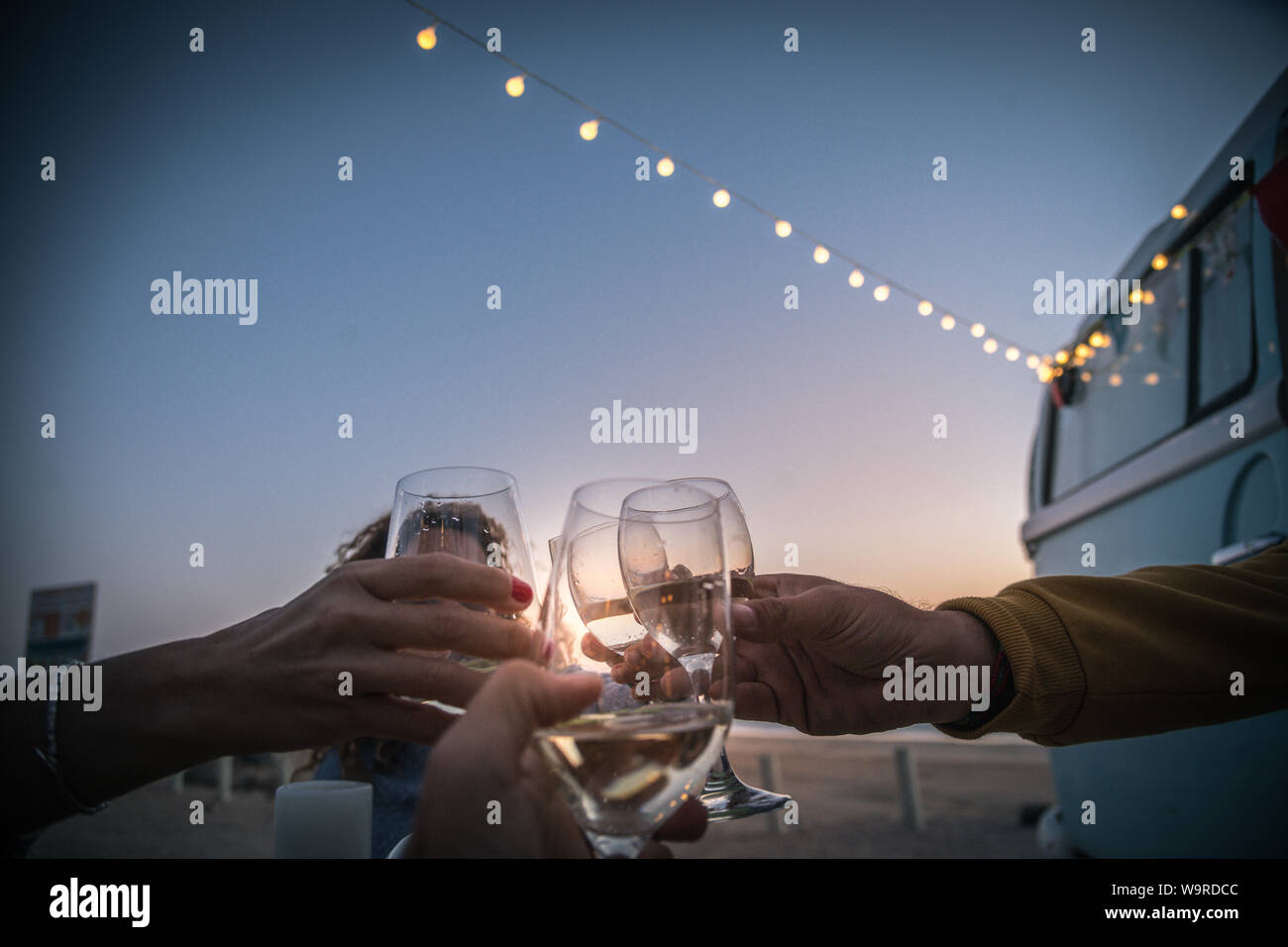 Happy friends cheering and drinking wine during camping vacation at the ...