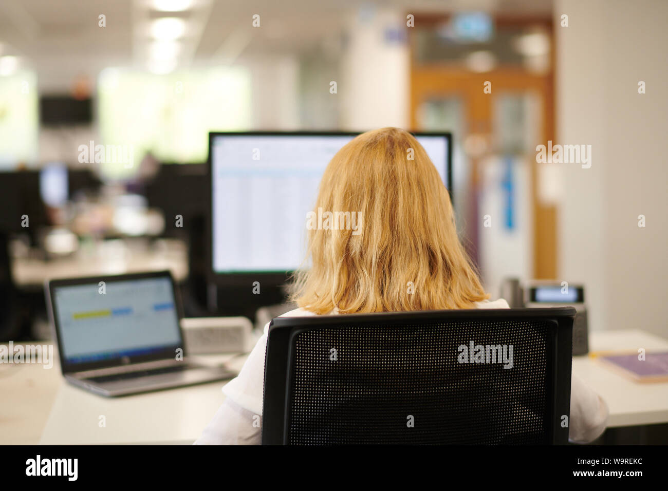At the office working Stock Photo - Alamy