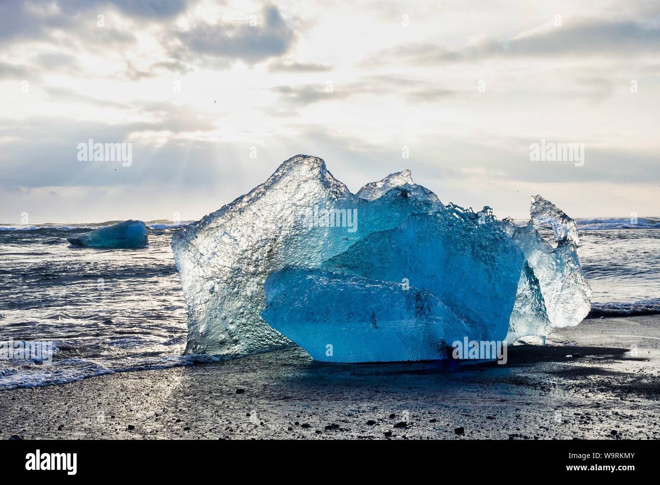 Iceberg at Diamond Beach Joekulsarlon. Blue chunk of ice on the black ...