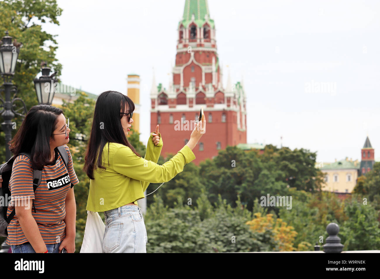 Asian girls tourists taking a selfie on a smartphone standing on ...