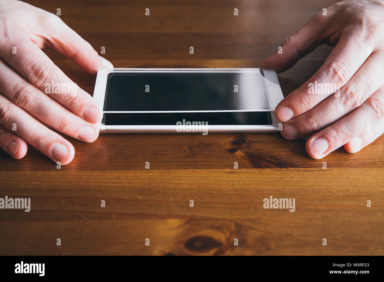 Man hands fingers hold smartphone screen protective covering glass on ...