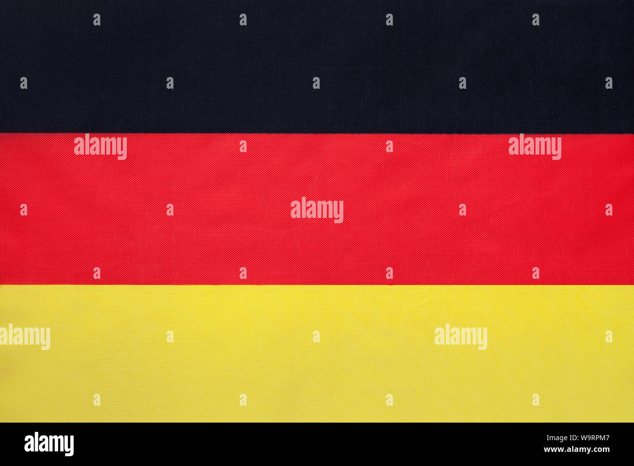 German national fabric flag with emblem, textile background. Symbol of ...