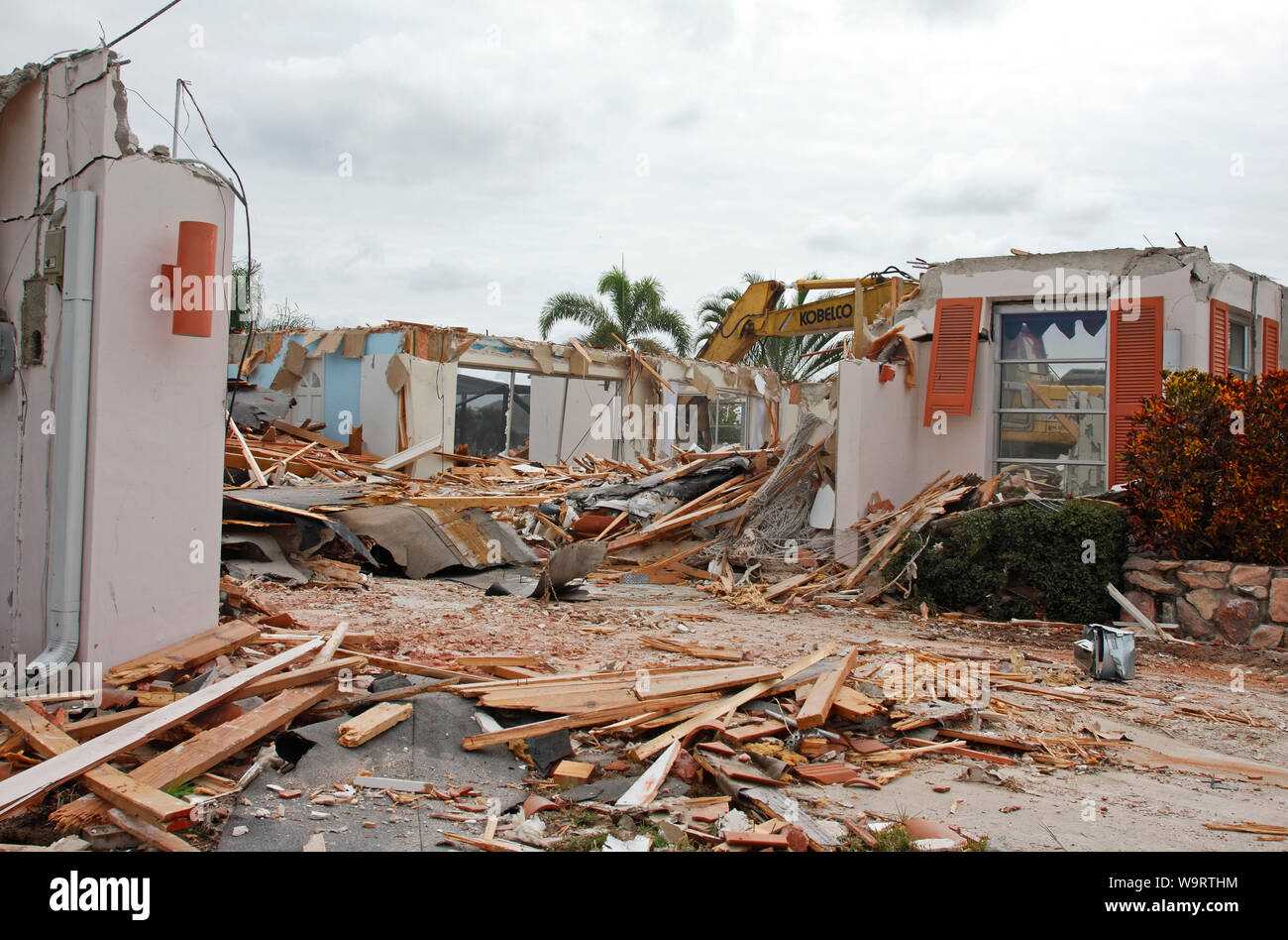 house being demolished; exterior walls standing, debris inside ...