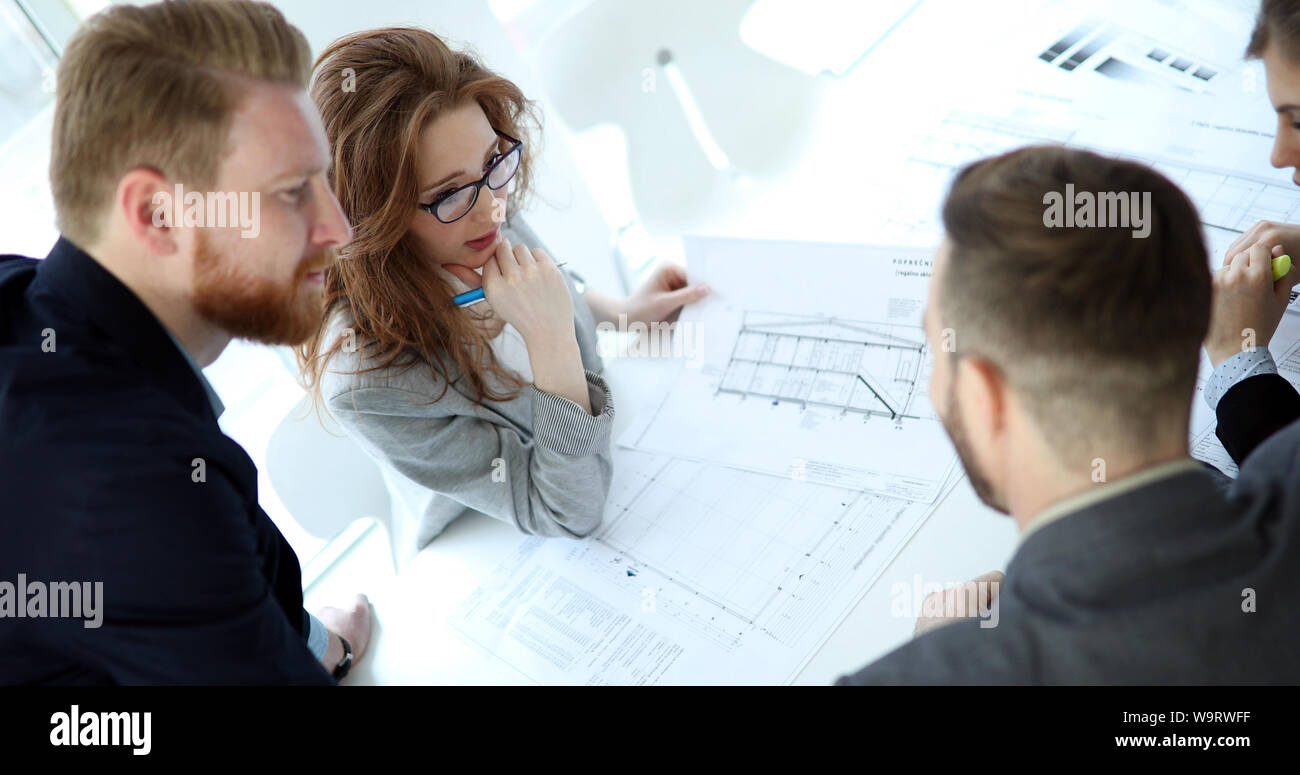 Group of architects working together on project Stock Photo - Alamy