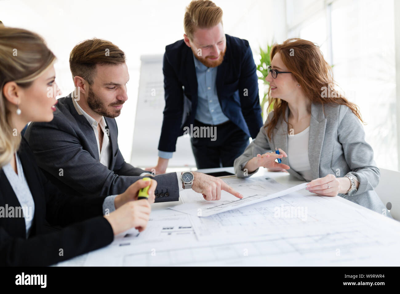 Team of architects working together on project Stock Photo - Alamy