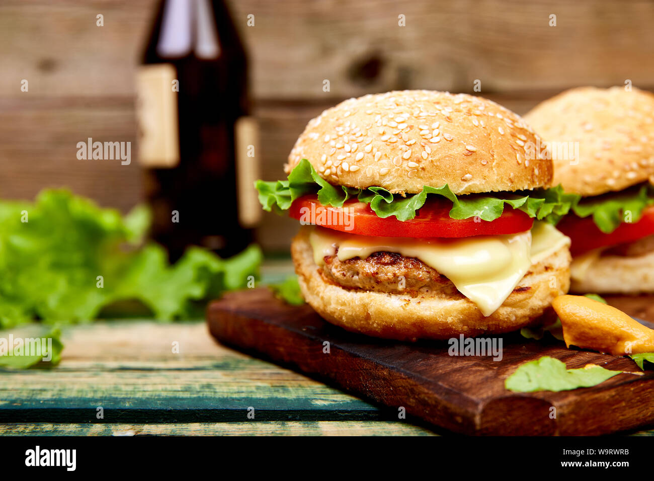 Craft beef burger on wooden table isolated on black background. Street ...