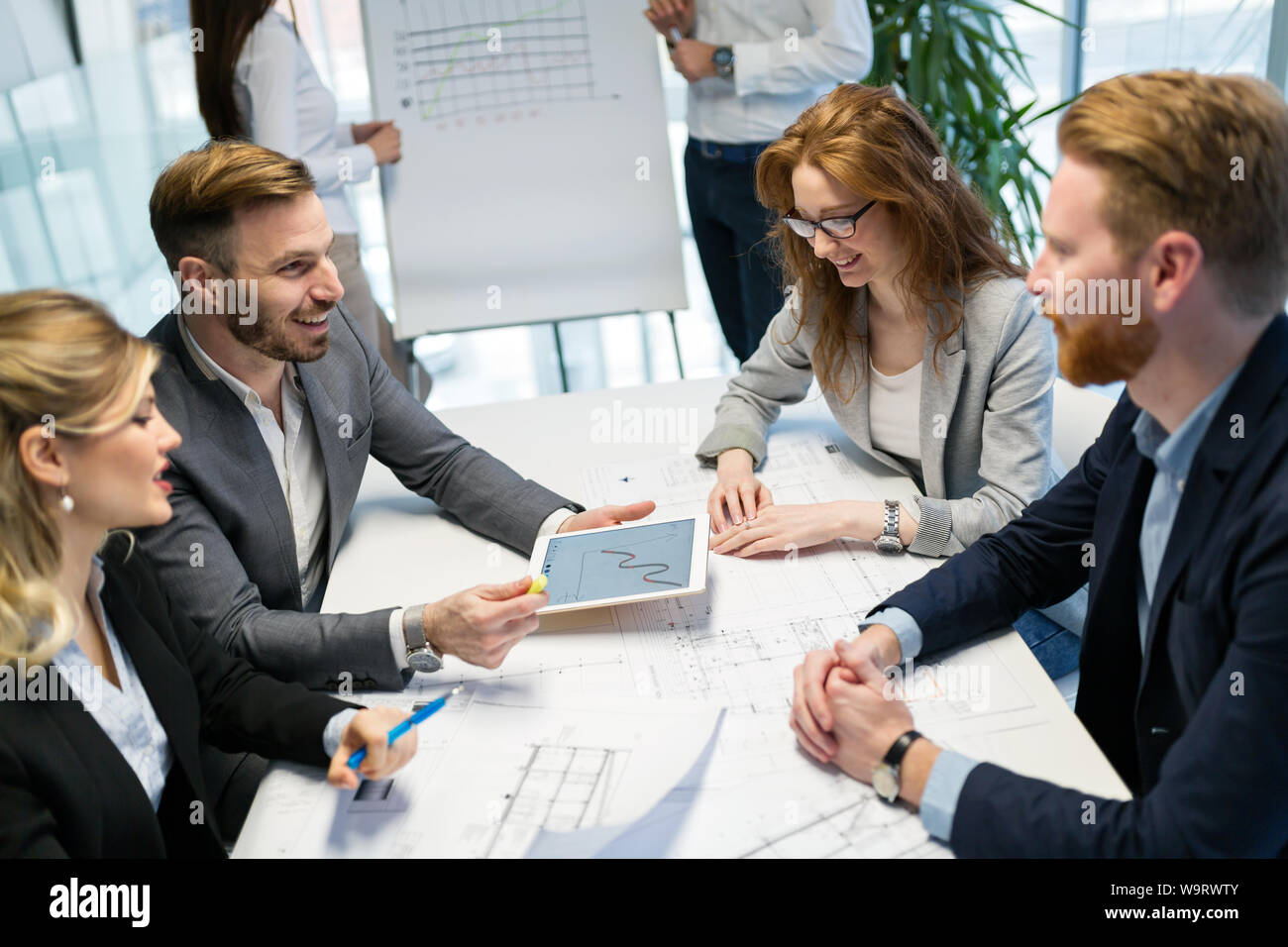 Team of architects working together on project Stock Photo - Alamy