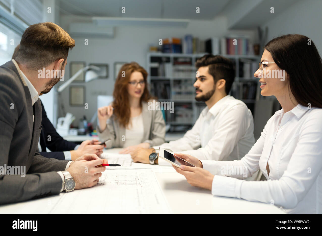 Team of architects working together on project Stock Photo - Alamy