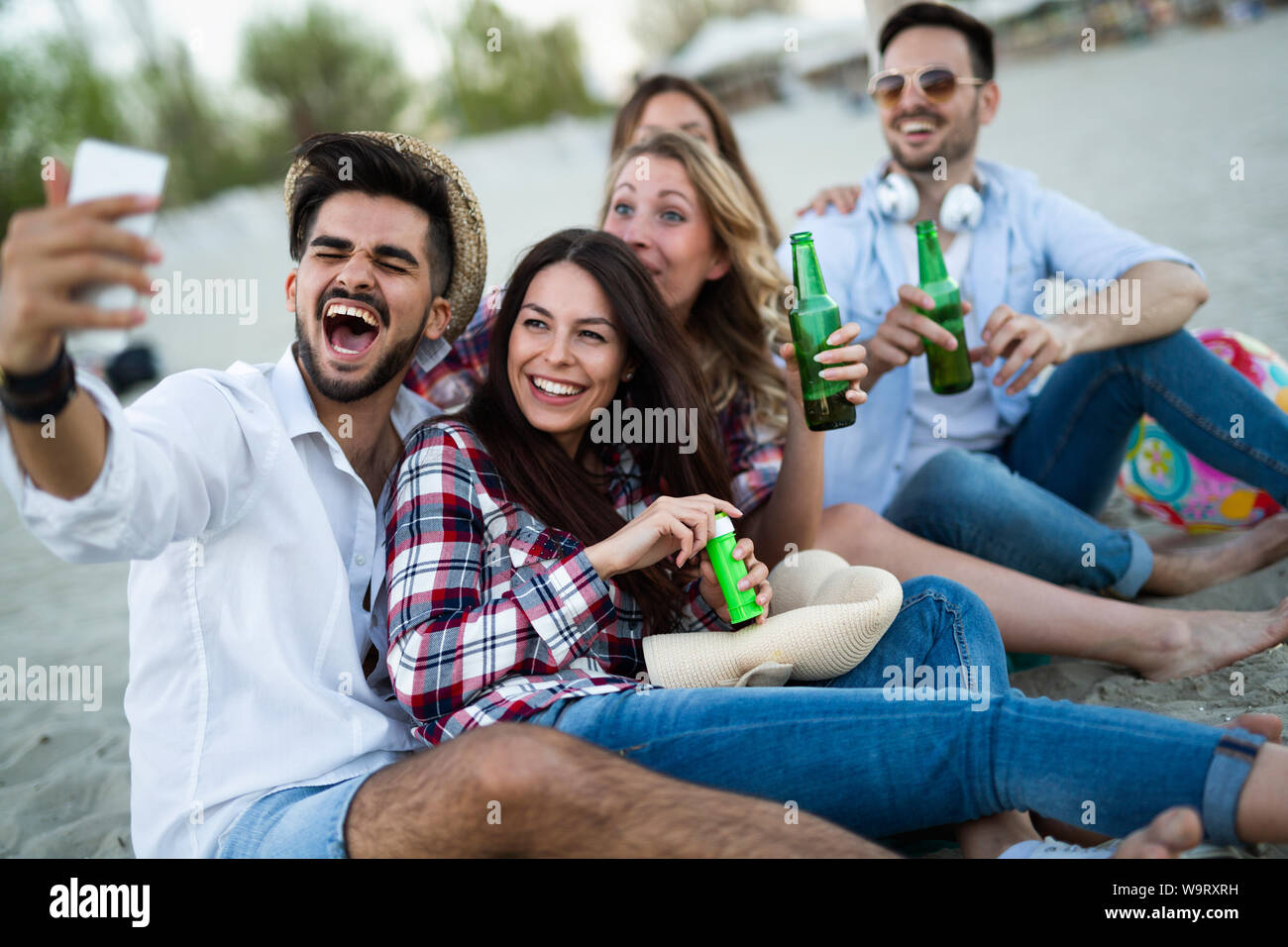 Happy group of young people having fun at beach Stock Photo - Alamy