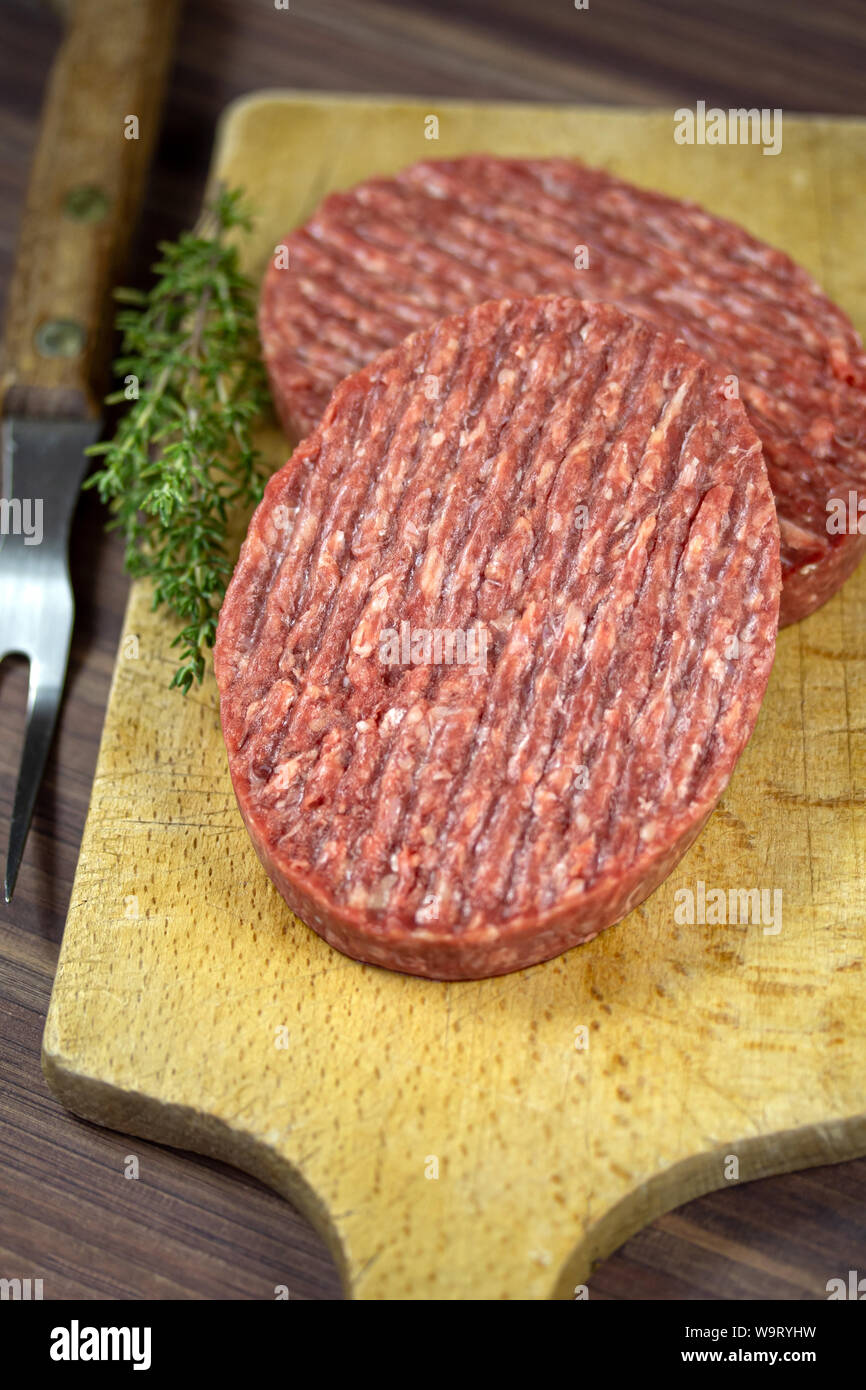 raw beef ground steaks on a cutting board Stock Photo - Alamy