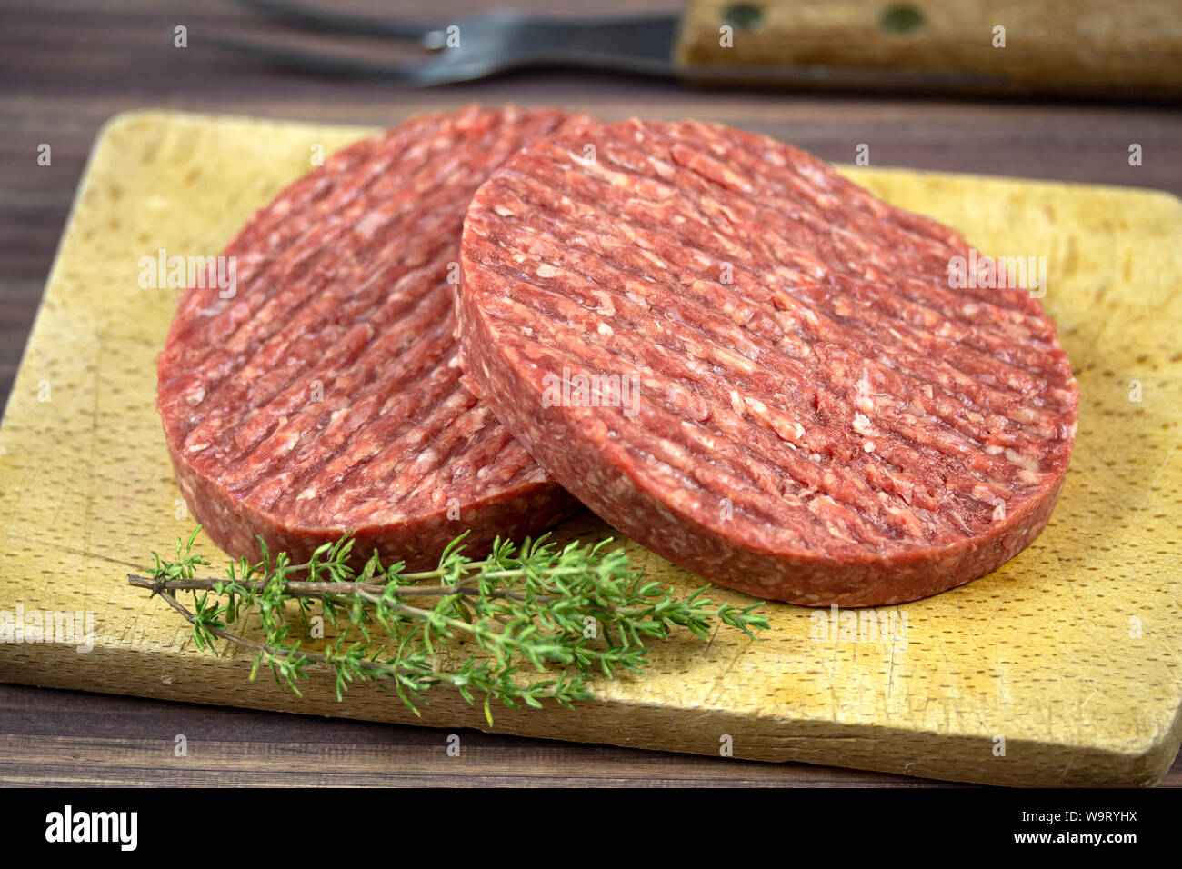 raw beef ground steaks on a cutting board Stock Photo - Alamy