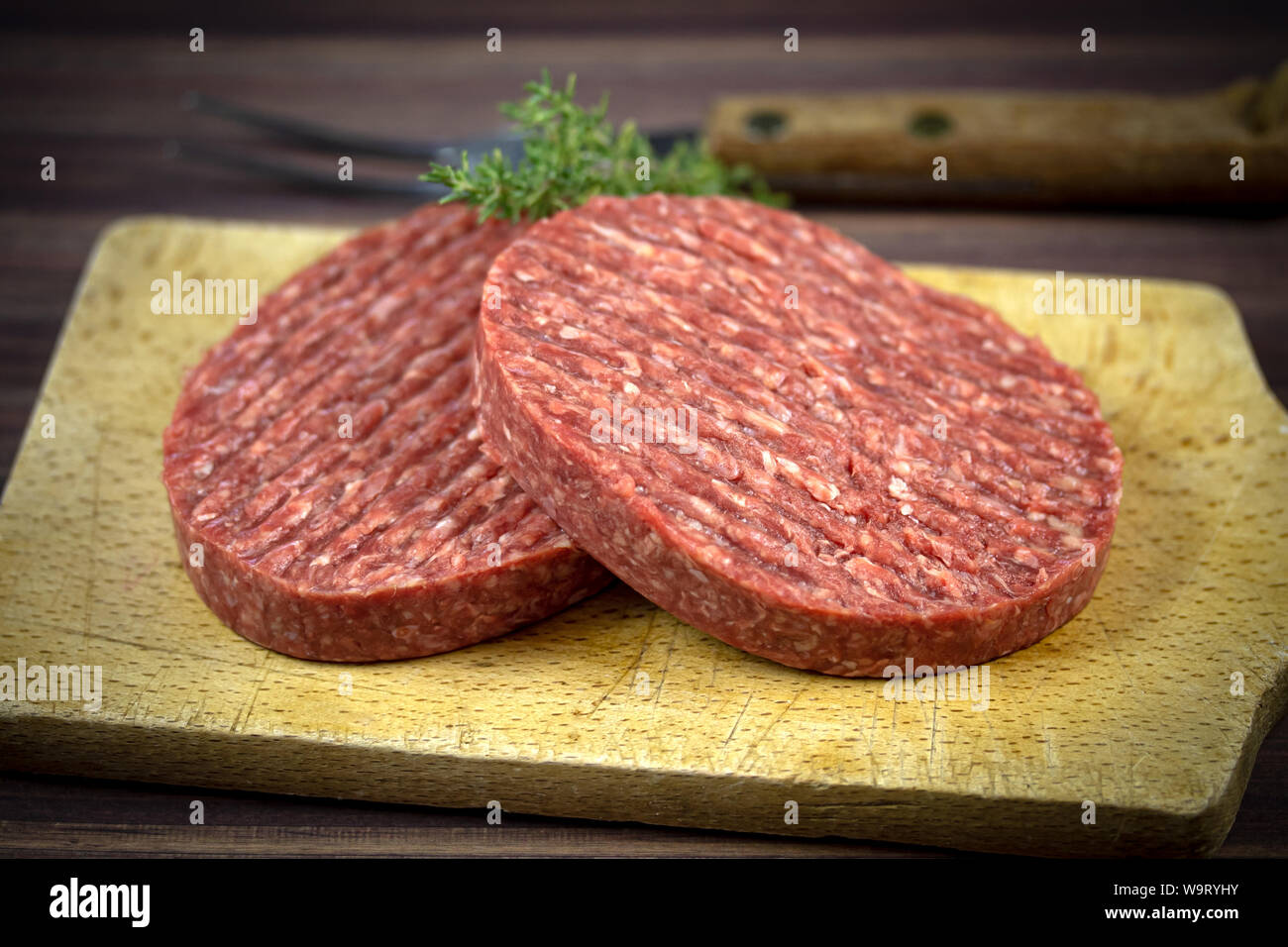 raw beef ground steaks on a cutting board Stock Photo - Alamy