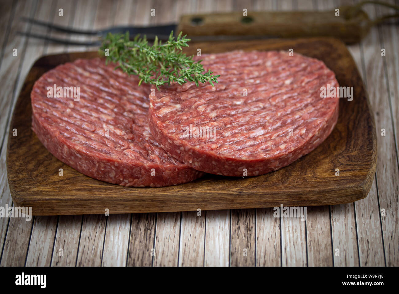 raw beef ground steaks on a cutting board Stock Photo - Alamy