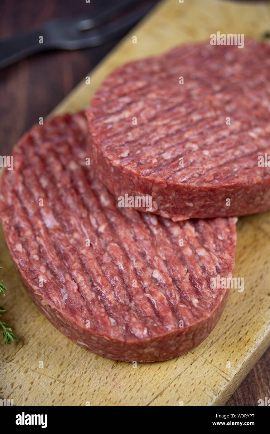raw beef ground steaks on a cutting board Stock Photo - Alamy